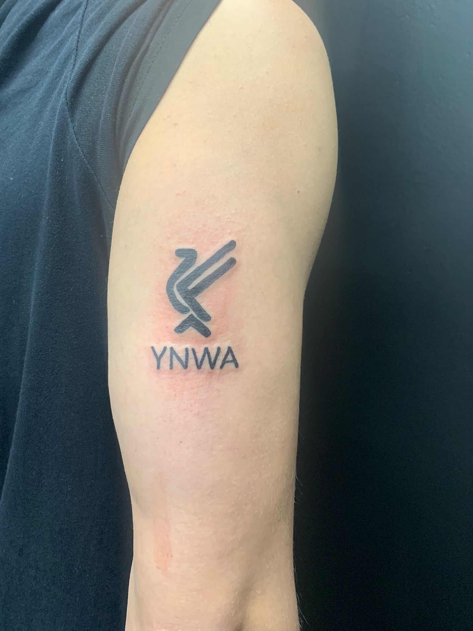 YNWA Logo Biceps Black And White Tattoo - TattoosAll